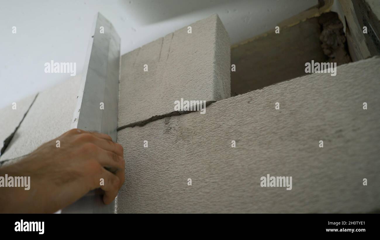 Renovation of a white block wall. View of the walls under construction ...