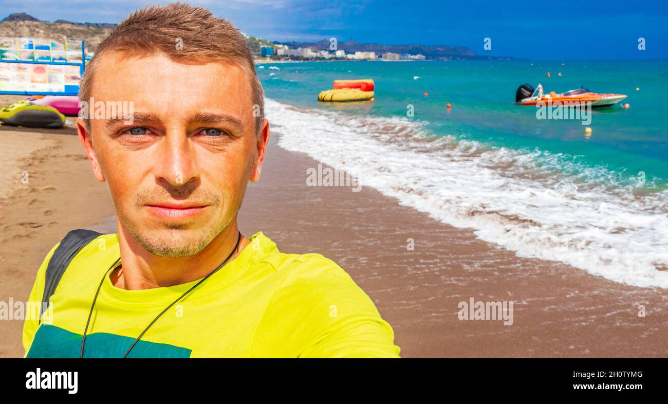 Russian tourist traveler at Faliraki Bay Beach with turquoise clear ...