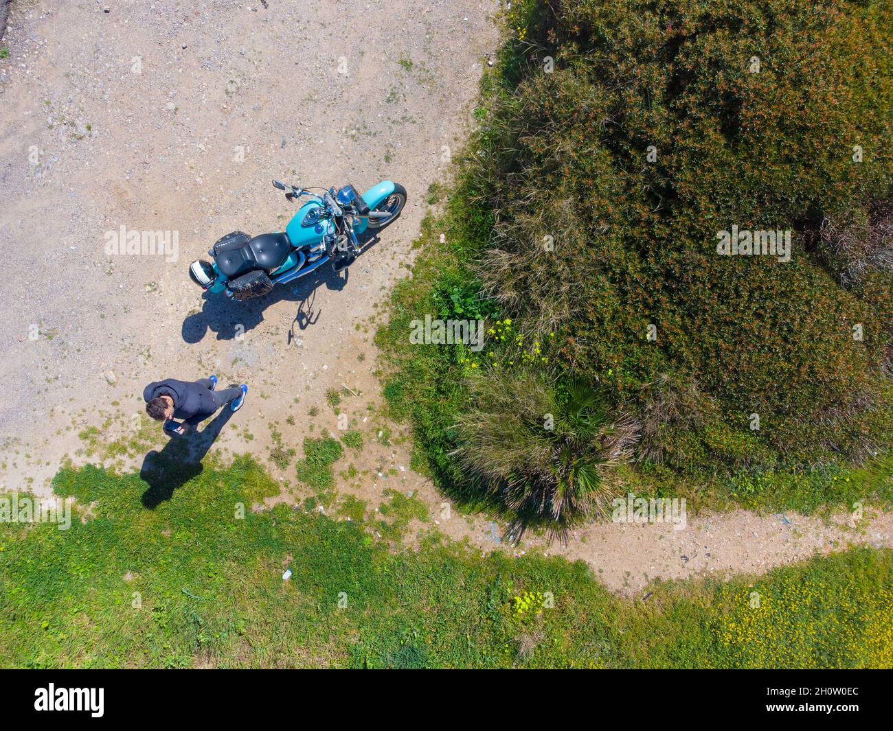 Man by a classic motorcycle seen from above Stock Photo - Alamy