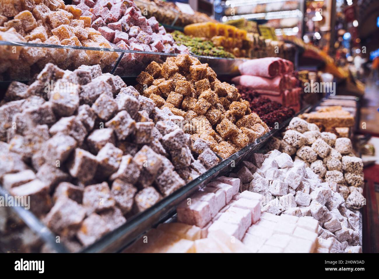 rows of Turkish delight sweets desserts with dried fruits lined up in ...