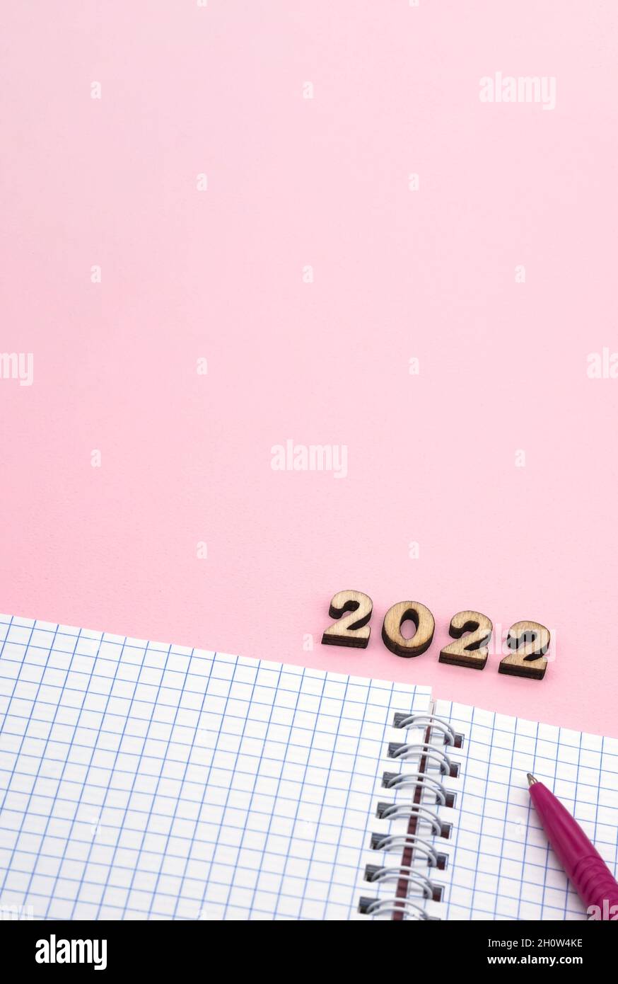 Wooden numbers 2022. Notepad on a spring. Notepad and Pen on Pink. Pink ...