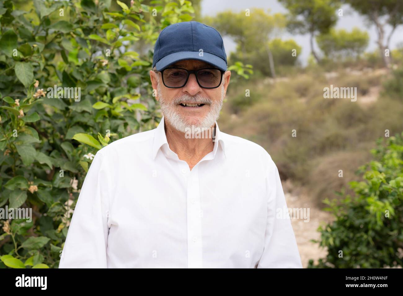 Elderly man smiling outdoors in nature Stock Photo - Alamy