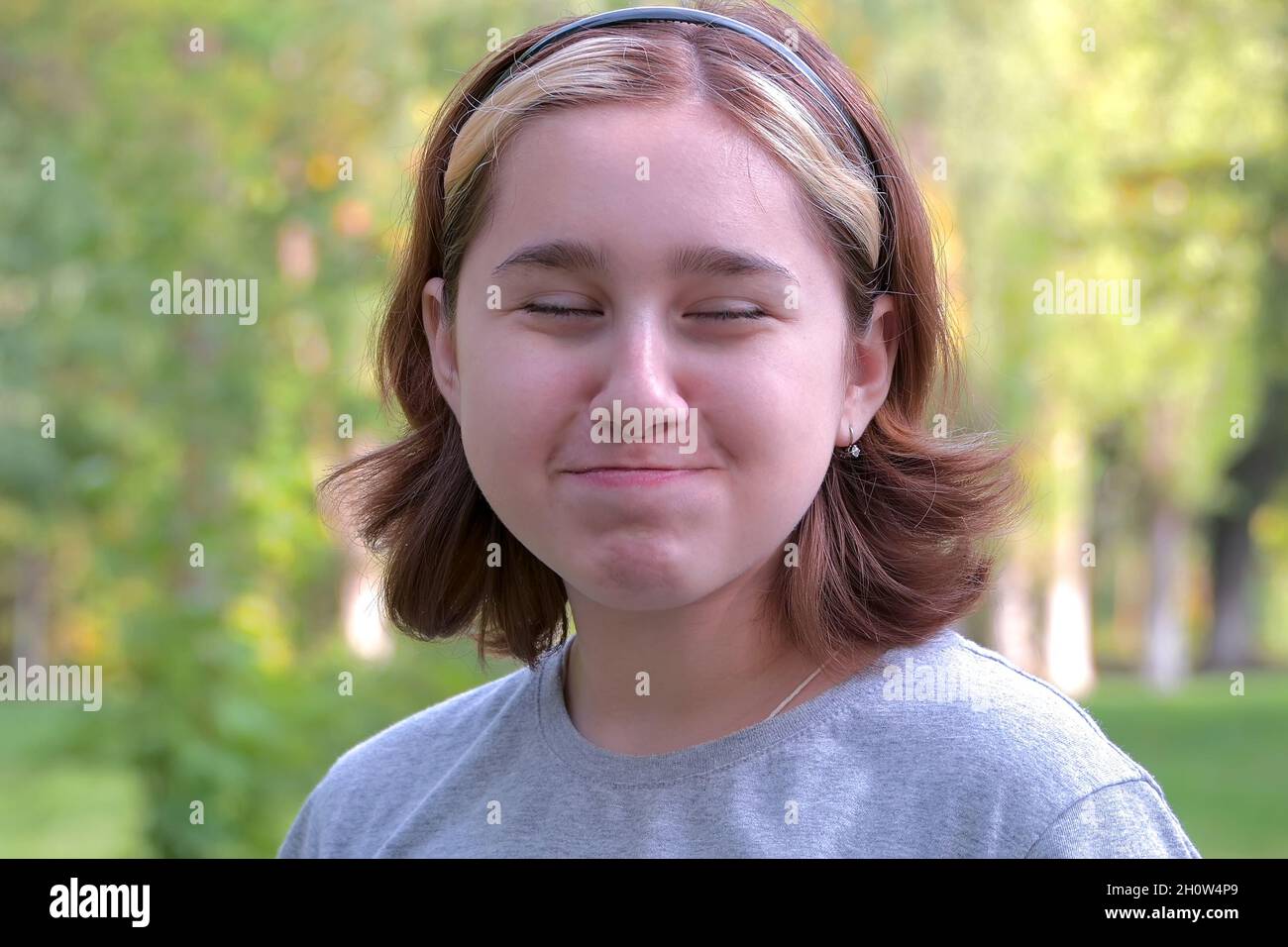 a teenage girl with an Asian appearance chews up leftovers and laughs ...