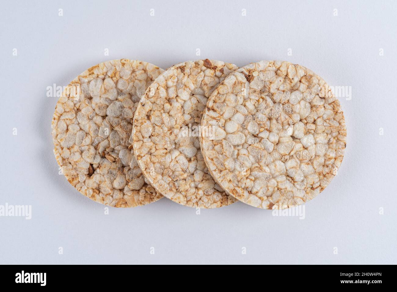 Pile of three rice cakes on white backdrop. Food background Stock Photo ...