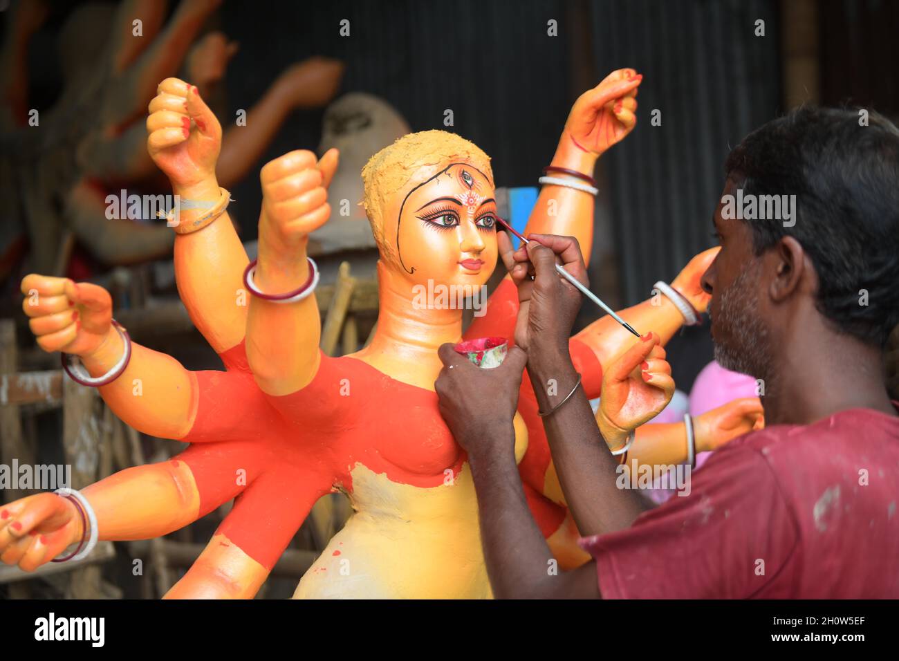 An artist drawing the eyes of Mother Goddess Durga ahead of Durga Puja ...