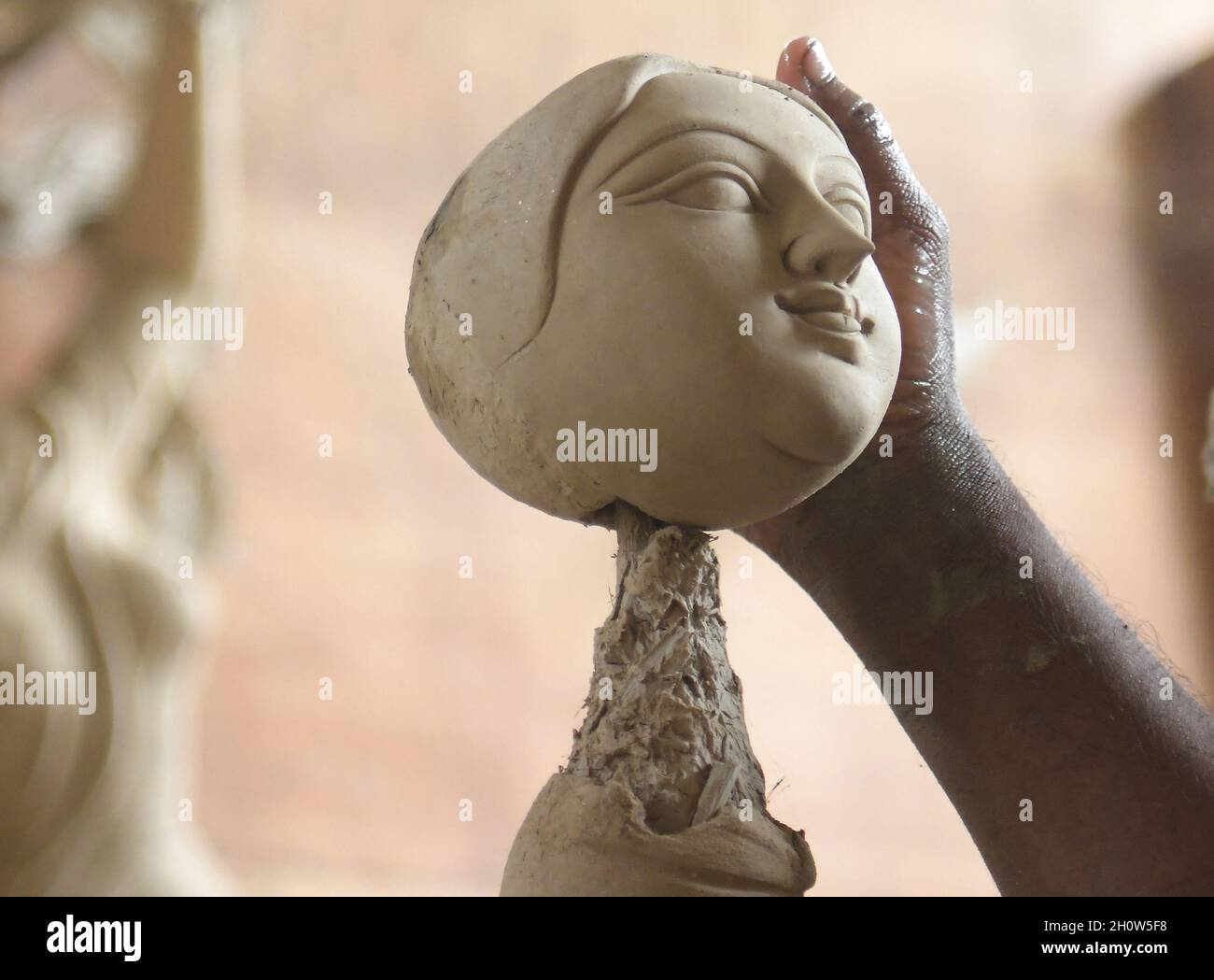 An idol maker making clay idols of Hindu deity Durga at a studio ahead ...