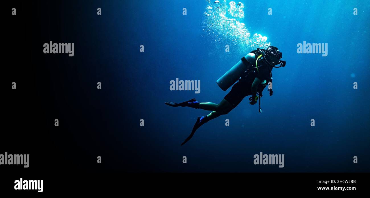 Woman scuba diving in deep blue sea banner on black background Stock ...