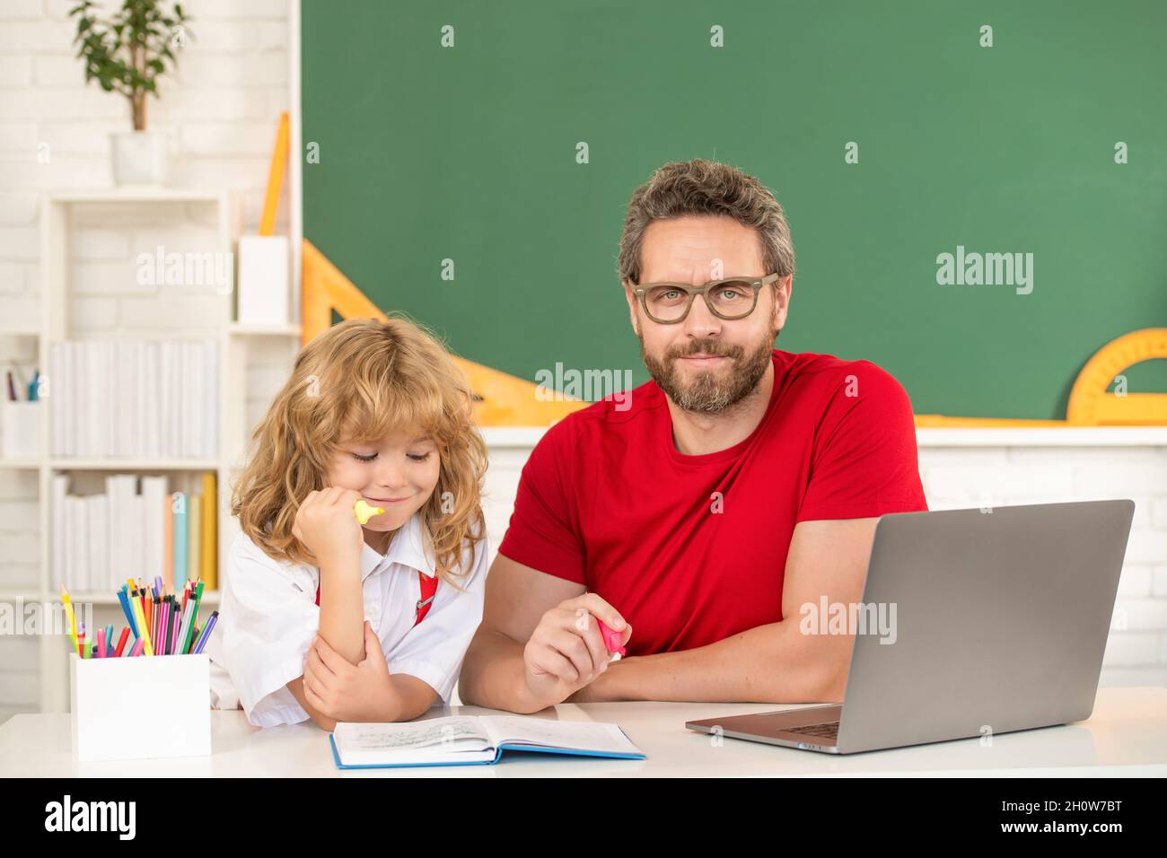 dad and son study in classroom with laptop, school online Stock Photo ...