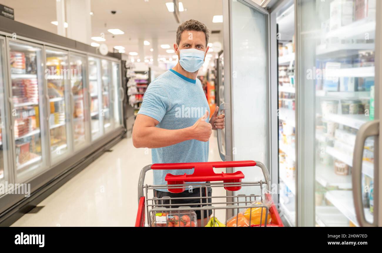 guy at grocery store. shopper at groceries. buying food at supermarket ...