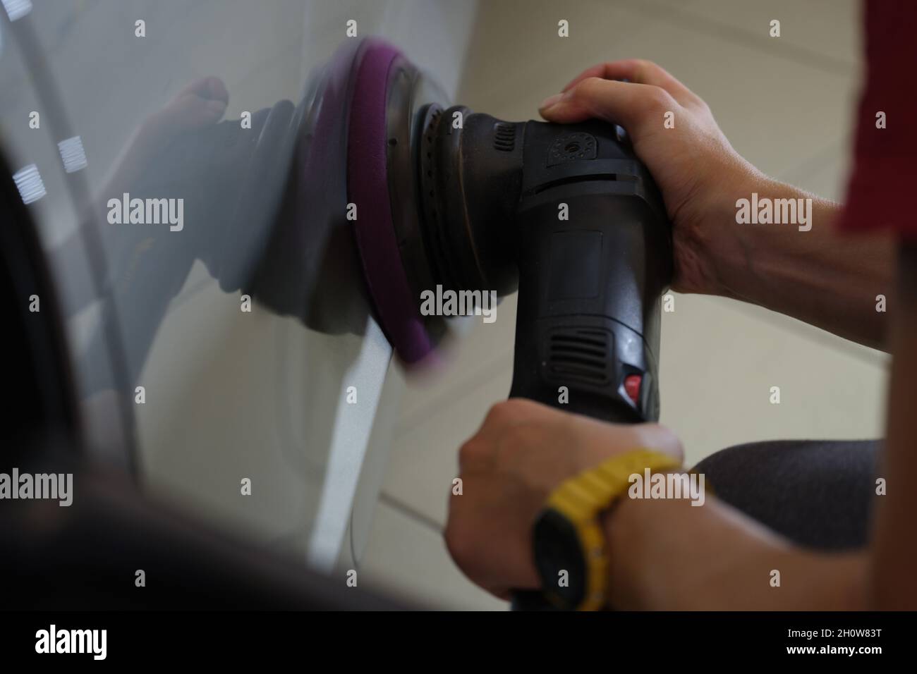 Master polishes car body from scuffs and scratches closeup Stock Photo ...