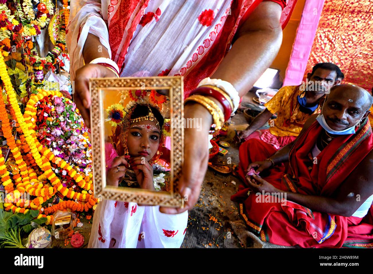 A picture of a little girl Dipwantita Adhikary of 10 years is shown by the Hindu devotees during ...