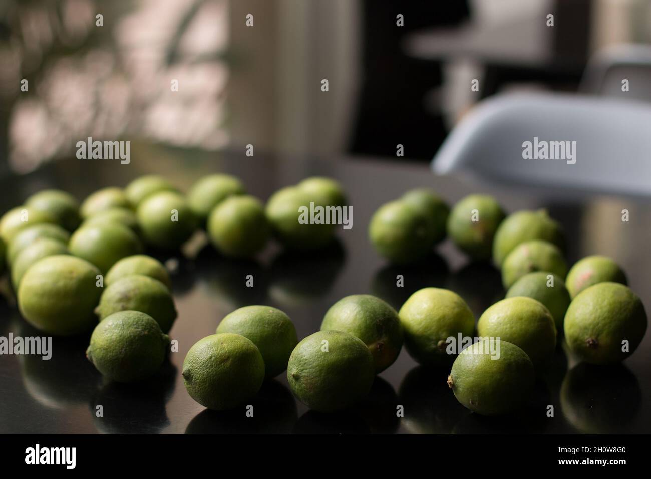 Soft focus of a bunch of fresh key limes on a table Stock Photo - Alamy