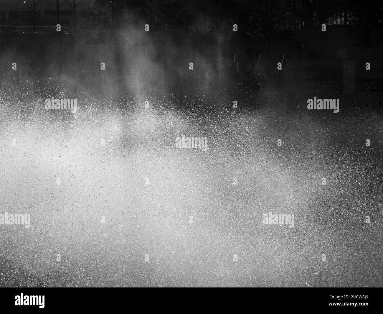 sunlight streaks through a fountain mist Stock Photo - Alamy