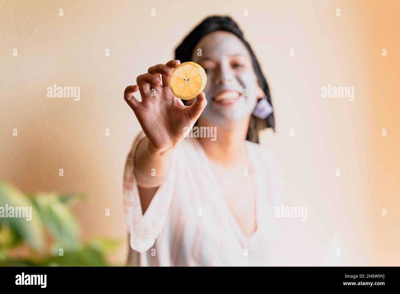 Happy girl applying a facial cleansing mask while Stock Photo - Alamy