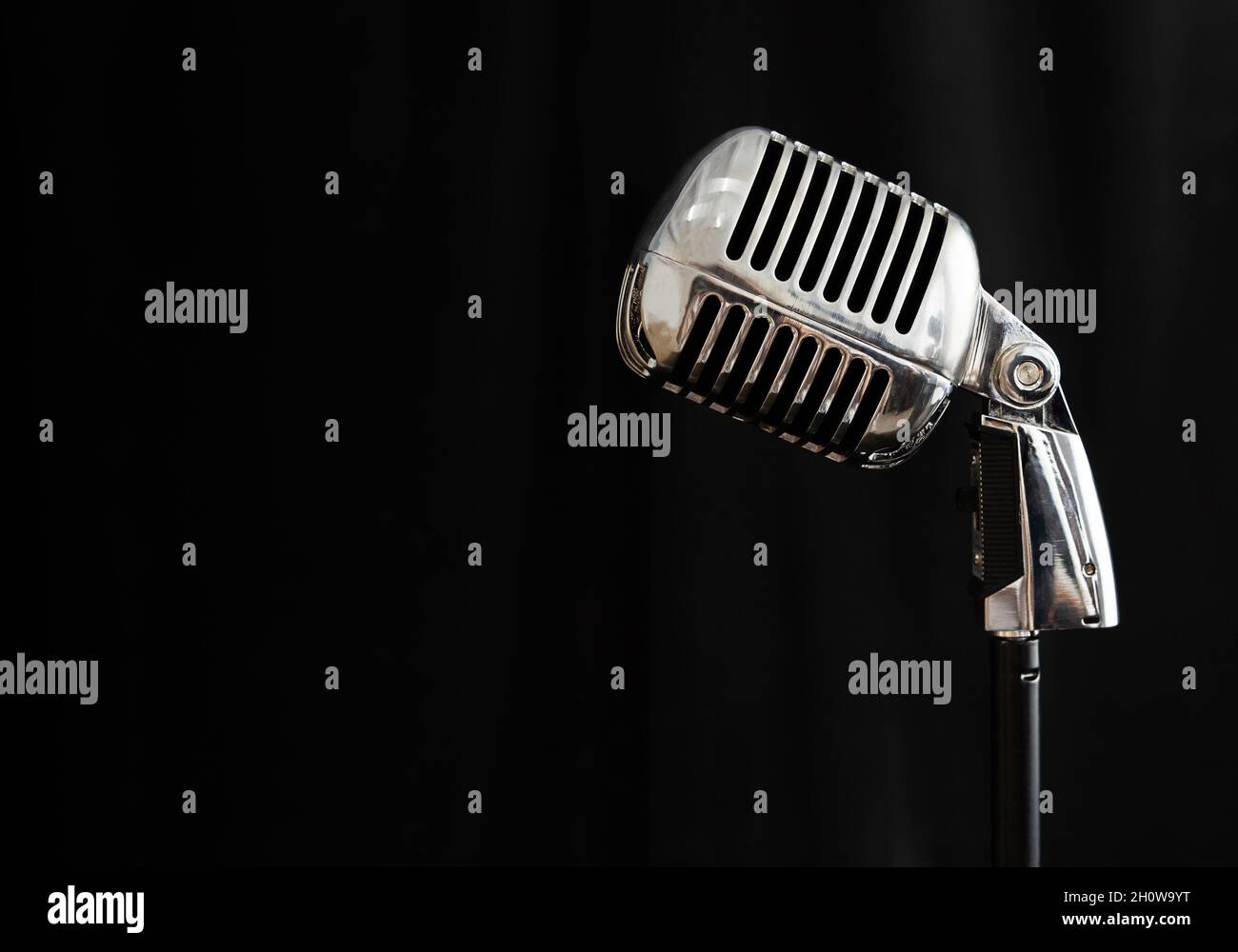 silver microphone in retro style on black background Stock Photo - Alamy