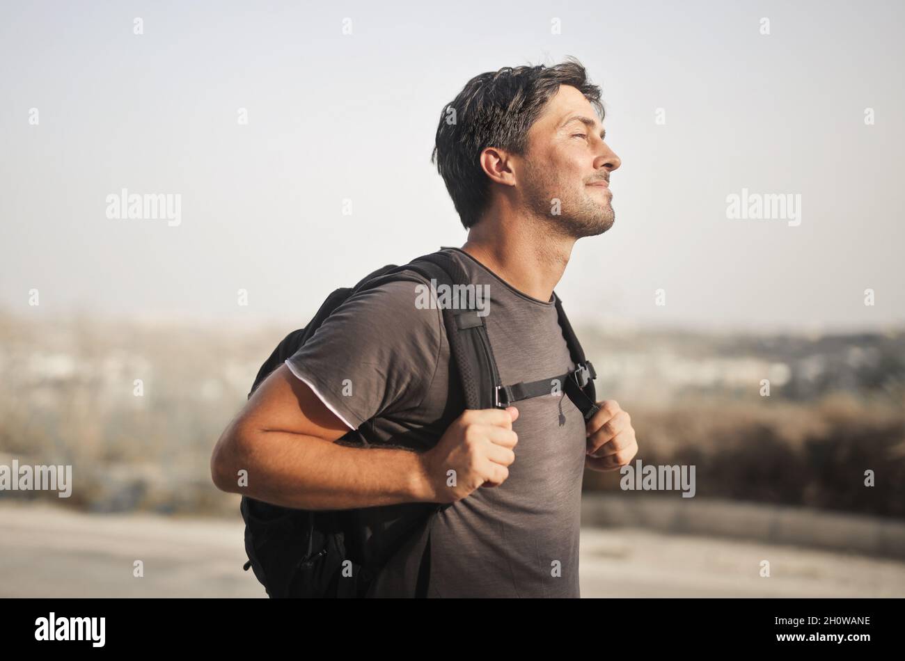portrait of young man with rucksack Stock Photo - Alamy
