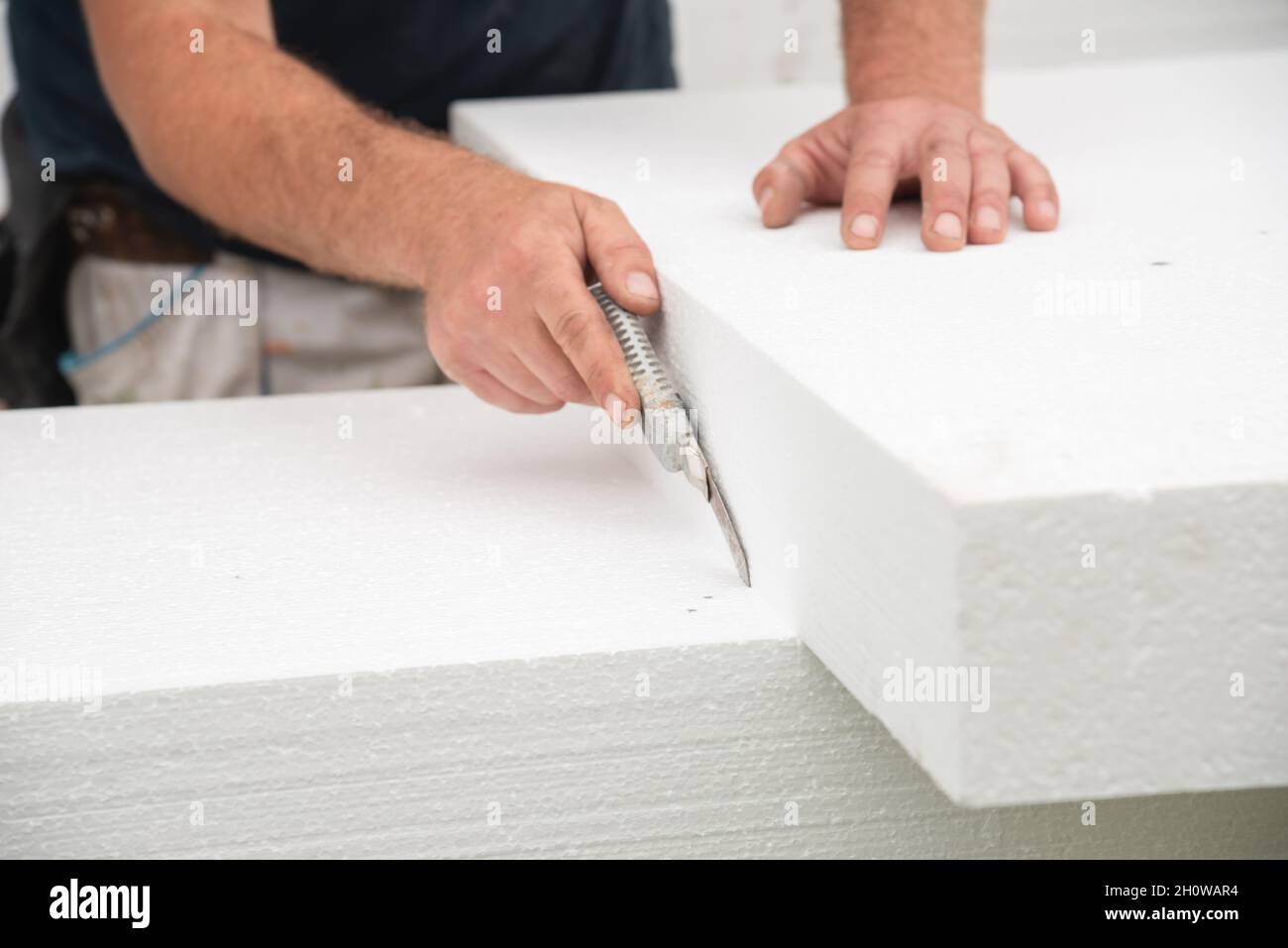 Cutting styrofoam block with exactoknife Stock Photo - Alamy