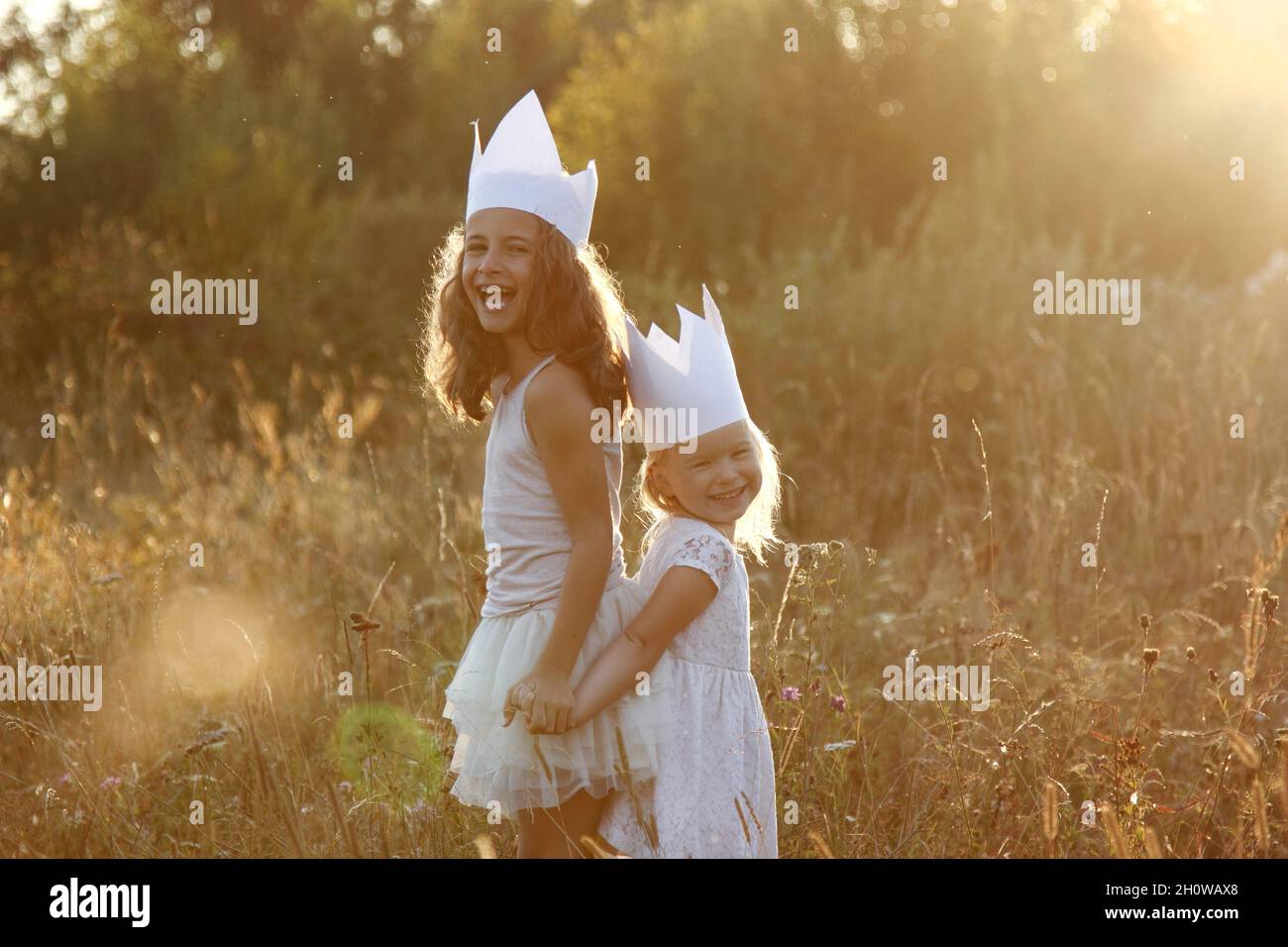 Two girls are playing princesses on the street Stock Photo - Alamy