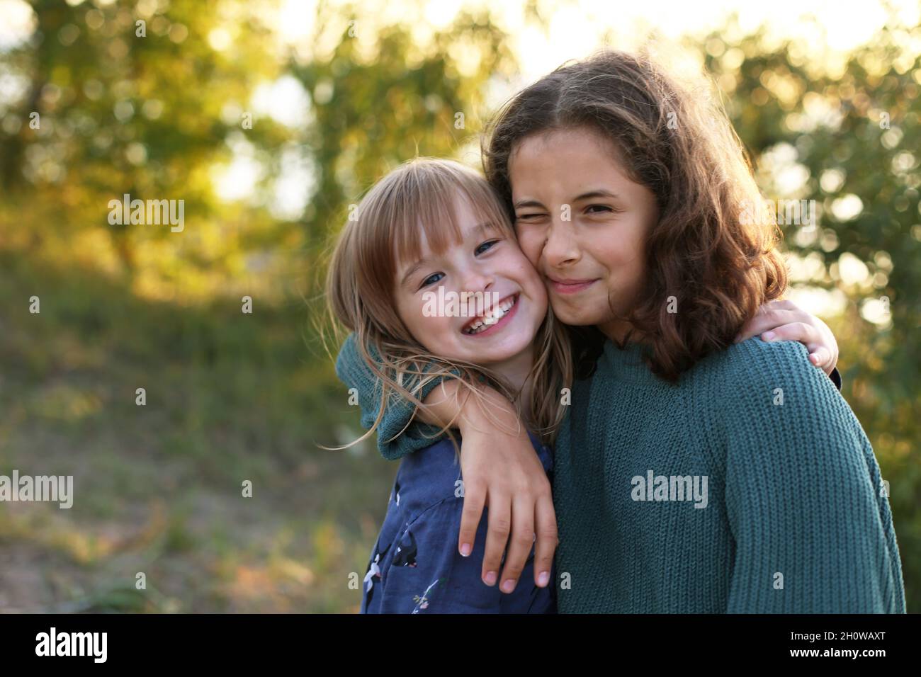 Close-up two children are hugging outside Stock Photo - Alamy