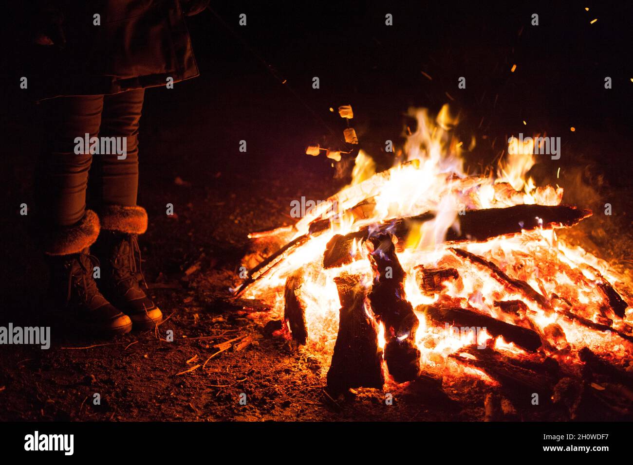 female standing near outdoor fire pit at night Stock Photo - Alamy