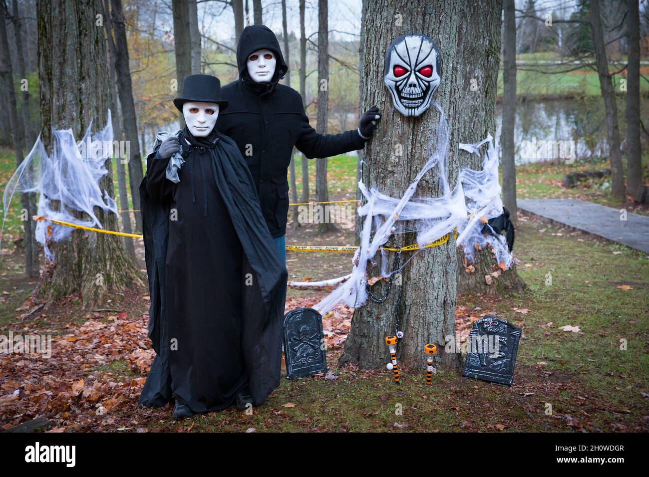 Halloween scene with two figures in masks Stock Photo - Alamy
