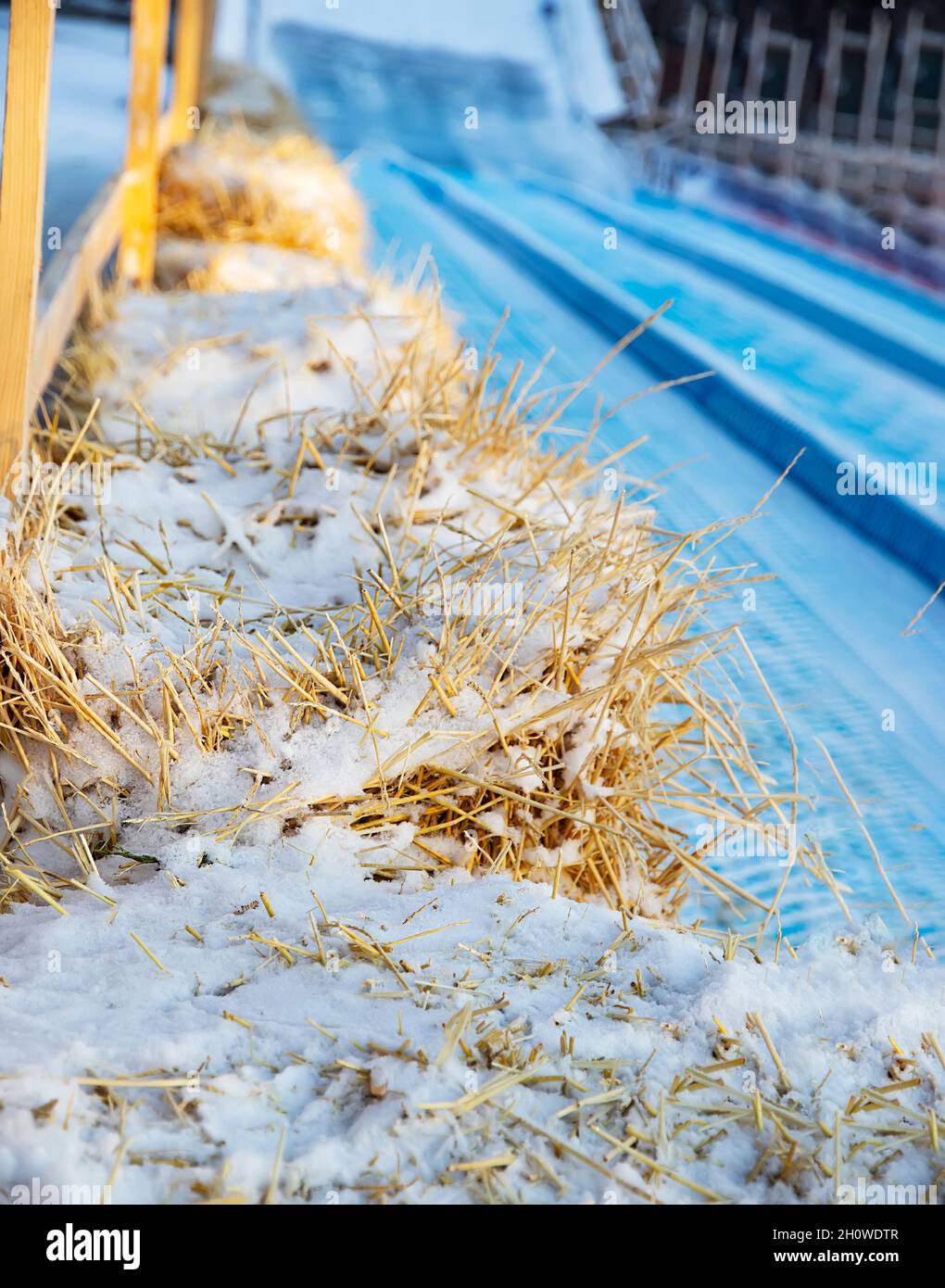 Blocks of straw covered with snow that line the toboggan run in winter ...