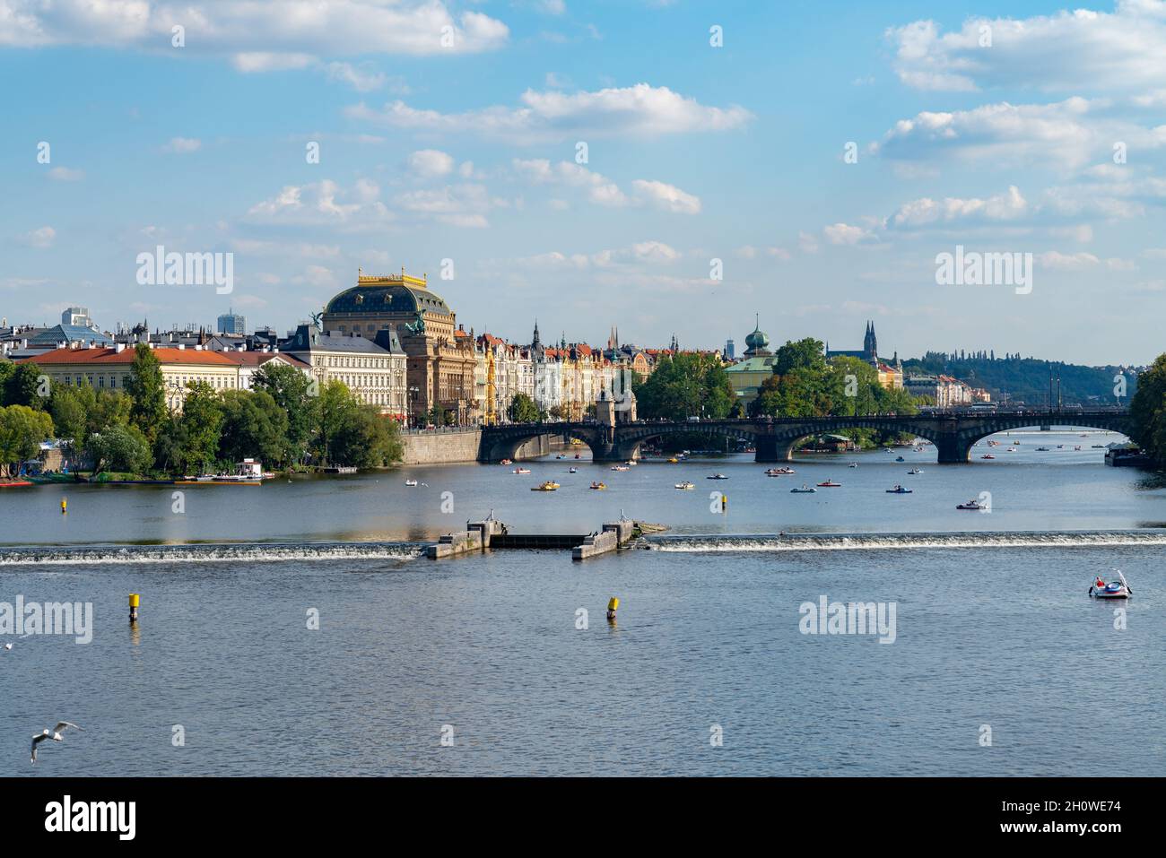 Vltava River view with city buildings and bridge in scenic image in ...