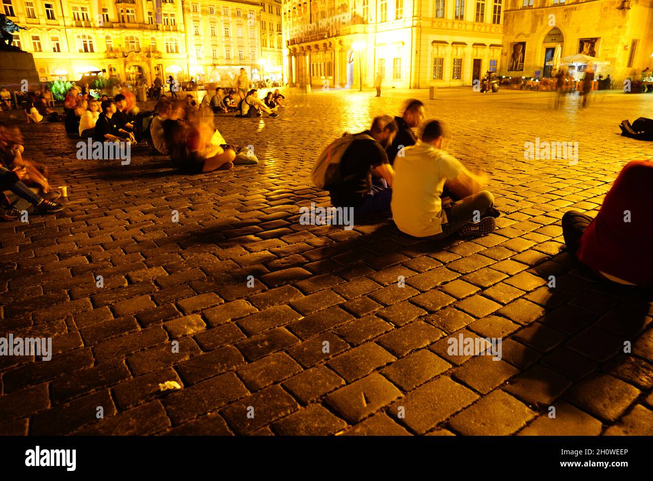 The blurred effect of long exposure movement of people sitting around a ...