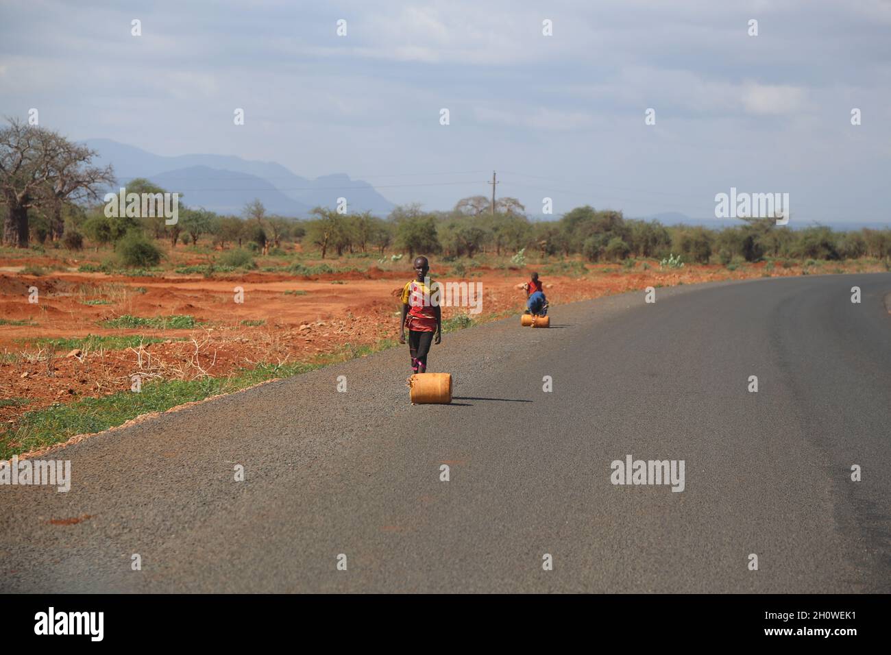 UKUNDA, KENYA - Dec 13, 2016: A view of people rolling the empty water ...