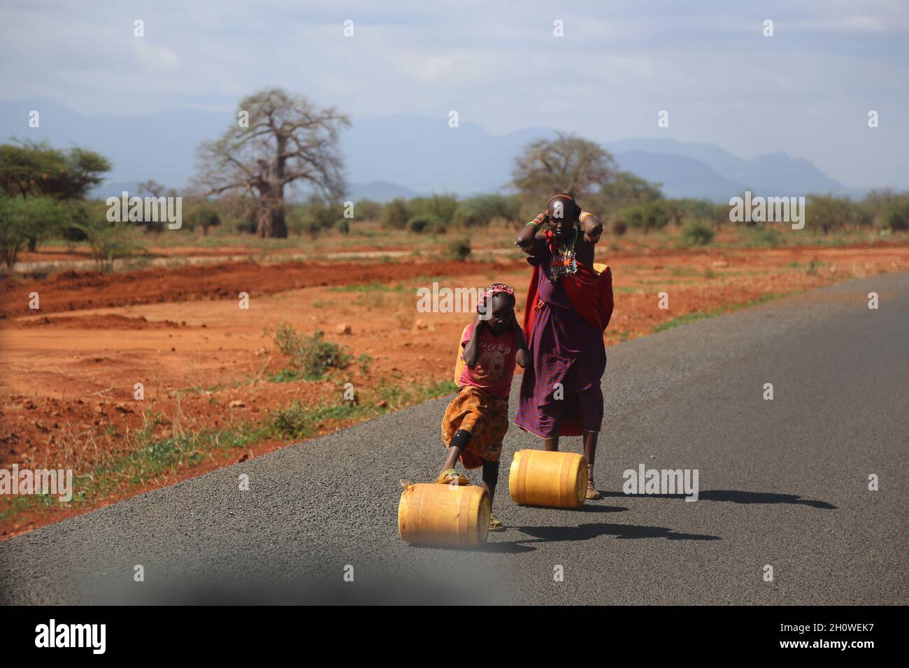 UKUNDA, KENYA - Dec 13, 2016: A view of people rolling the empty water ...