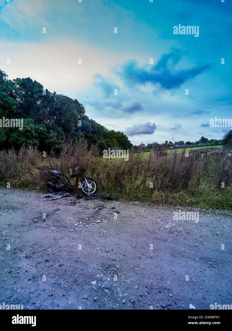 Burned out bike dumped onto recreational land, environmental pollution ...