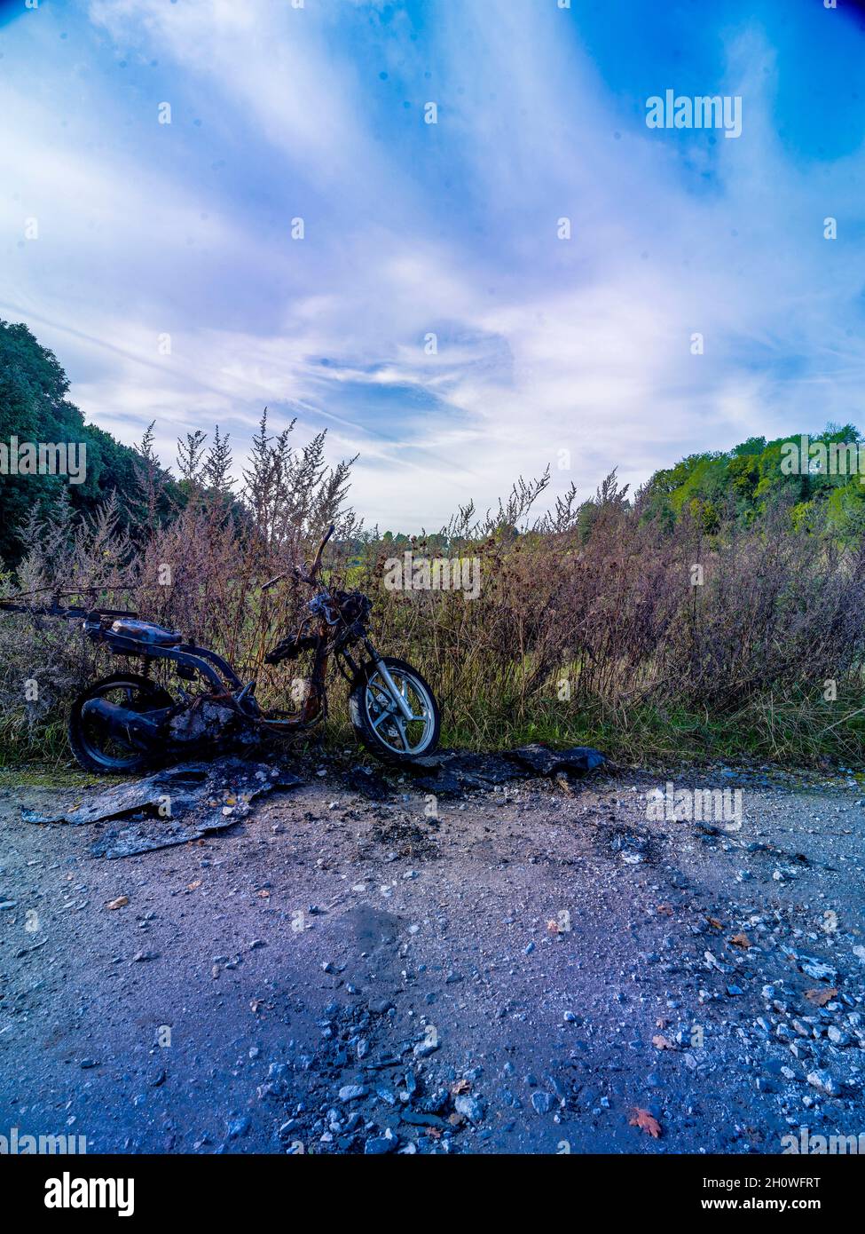 Burned out bike dumped onto recreational land, environmental pollution ...