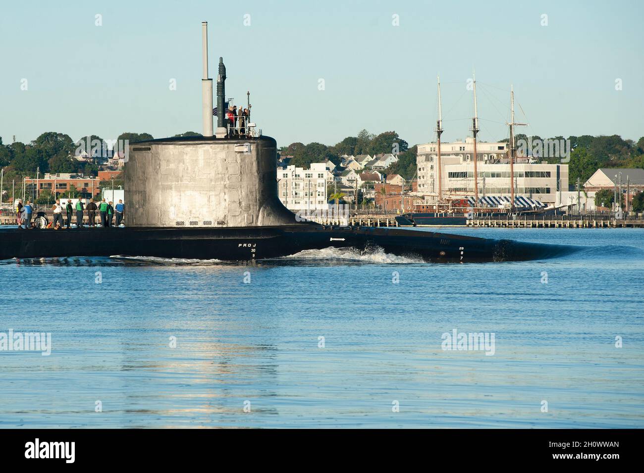 USS Delaware (SSN 791) makes its way up the Thames River and past the ...