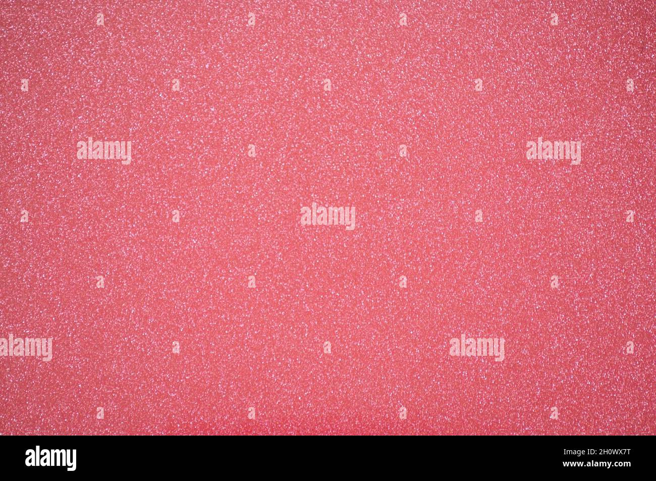 Bright red monochrome background with a scattering of small silvery ...
