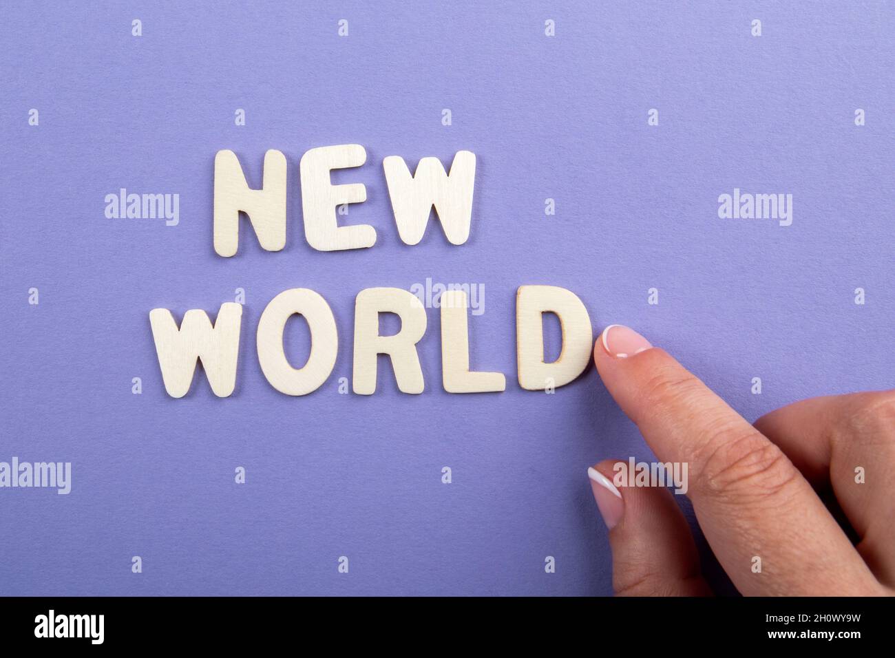 New World. White wooden alphabet letters on a purple background Stock ...
