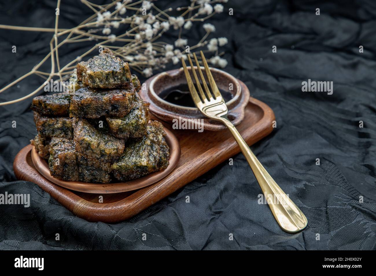 Crispy Fried Kuicheai Served with Sweet Black Soy Sauce on wooden plate ...