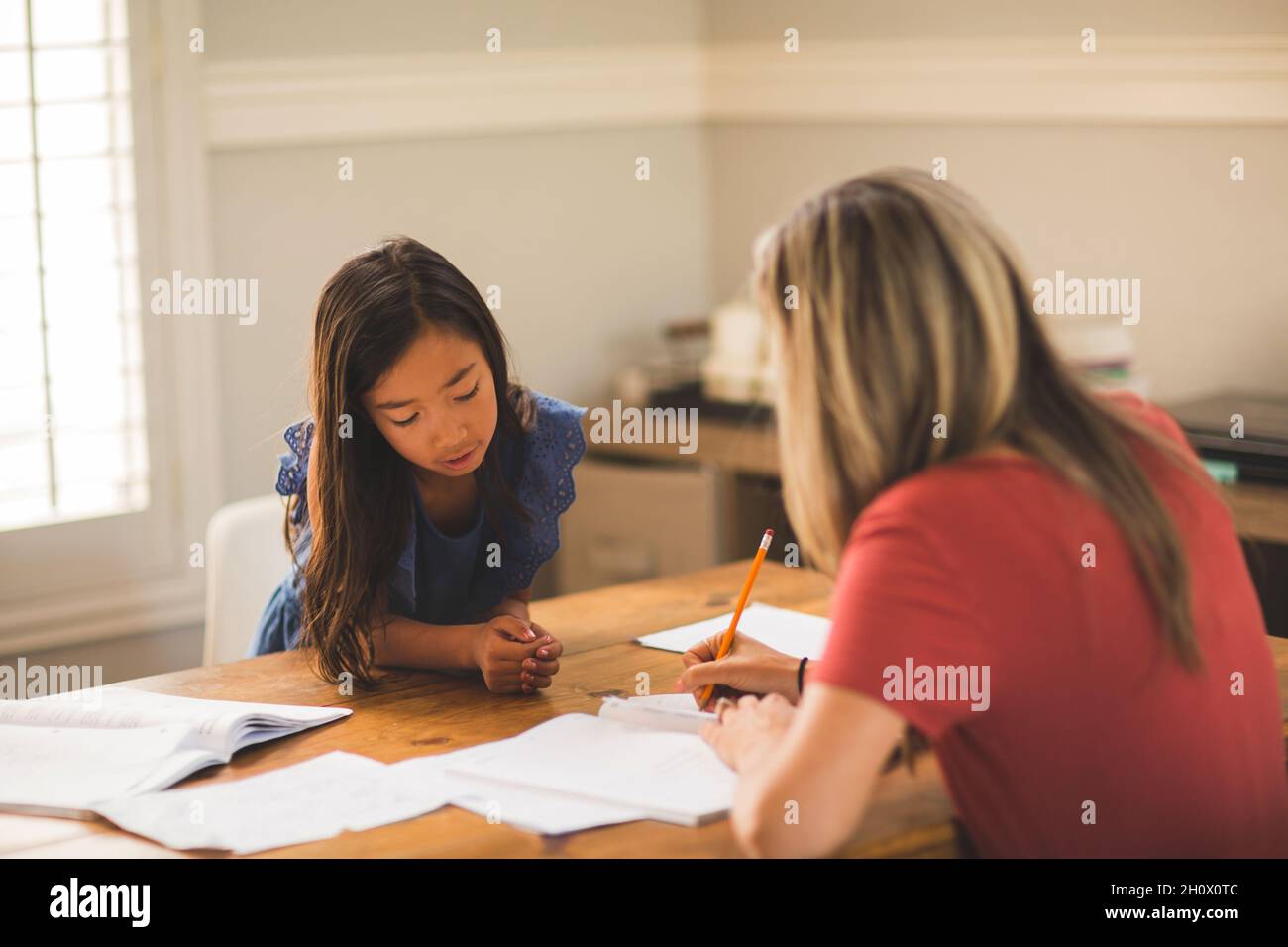 Teacher Helping Her Students With Their Homework School work Stock ...