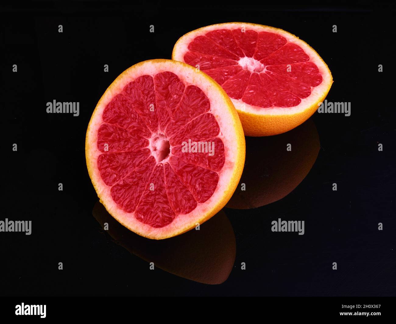Fresh grapefruit cut in half on dark background Stock Photo - Alamy