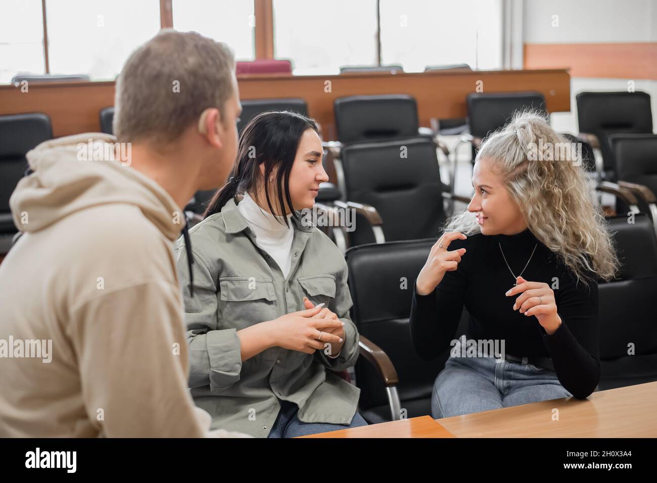 Deaf students showing sign language hi-res stock photography and images ...