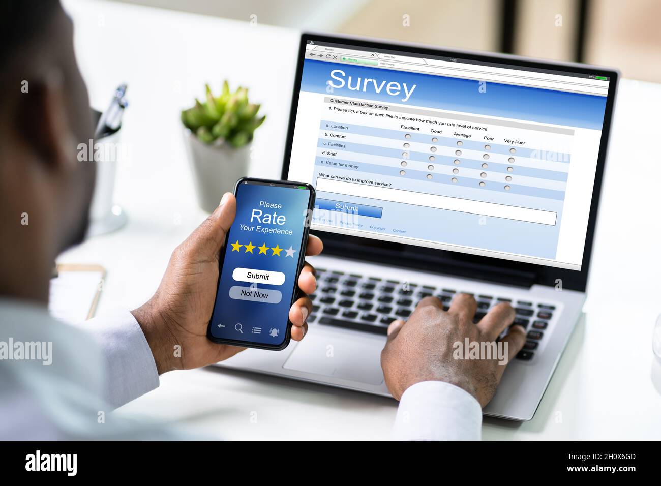 African Man Filling Survey Poll Or Form On Laptop Computer Stock Photo ...