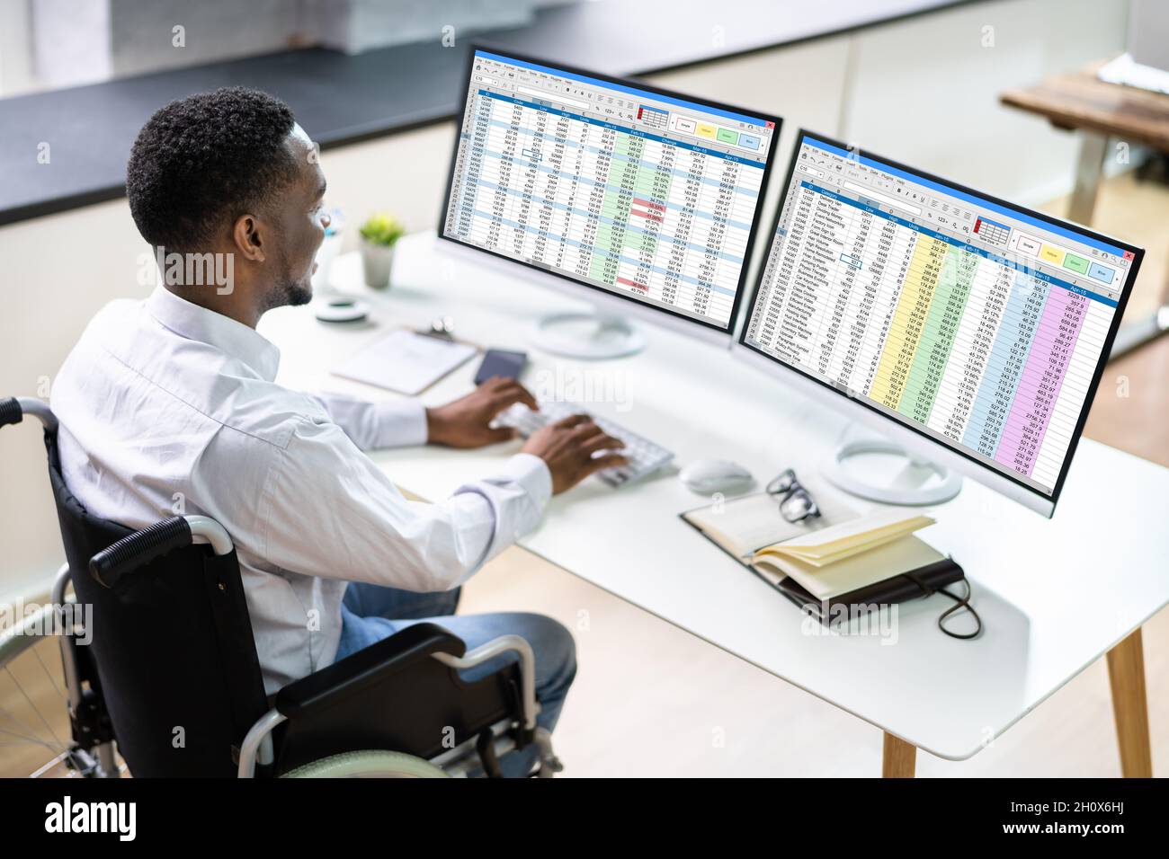 Medical Coding Spreadsheet On PC. African Man In Wheelchair Stock Photo ...