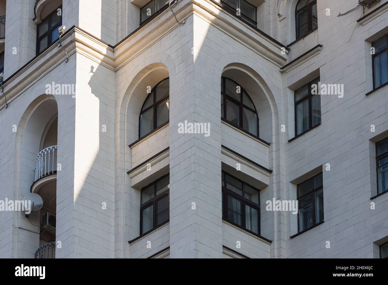 The faсade is a classic white stone building with rounded windows and a ...