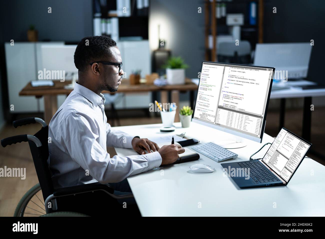 Disabled African Web Developer In Wheelchair Using Computer Stock Photo ...