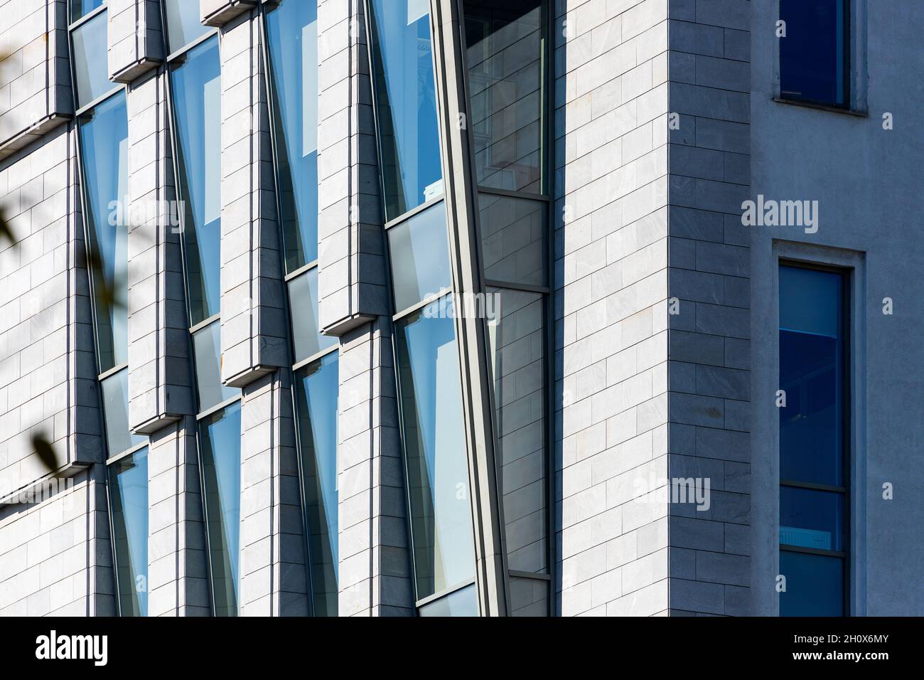 high-tech office building with transparent walls reflecting a bright ...