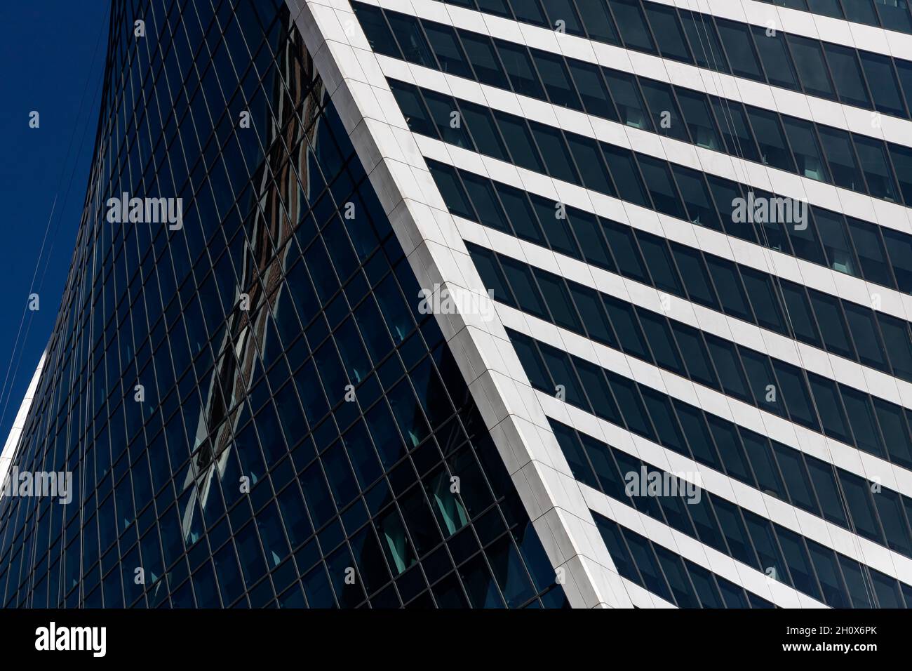 high-tech office building with transparent walls reflecting a bright ...