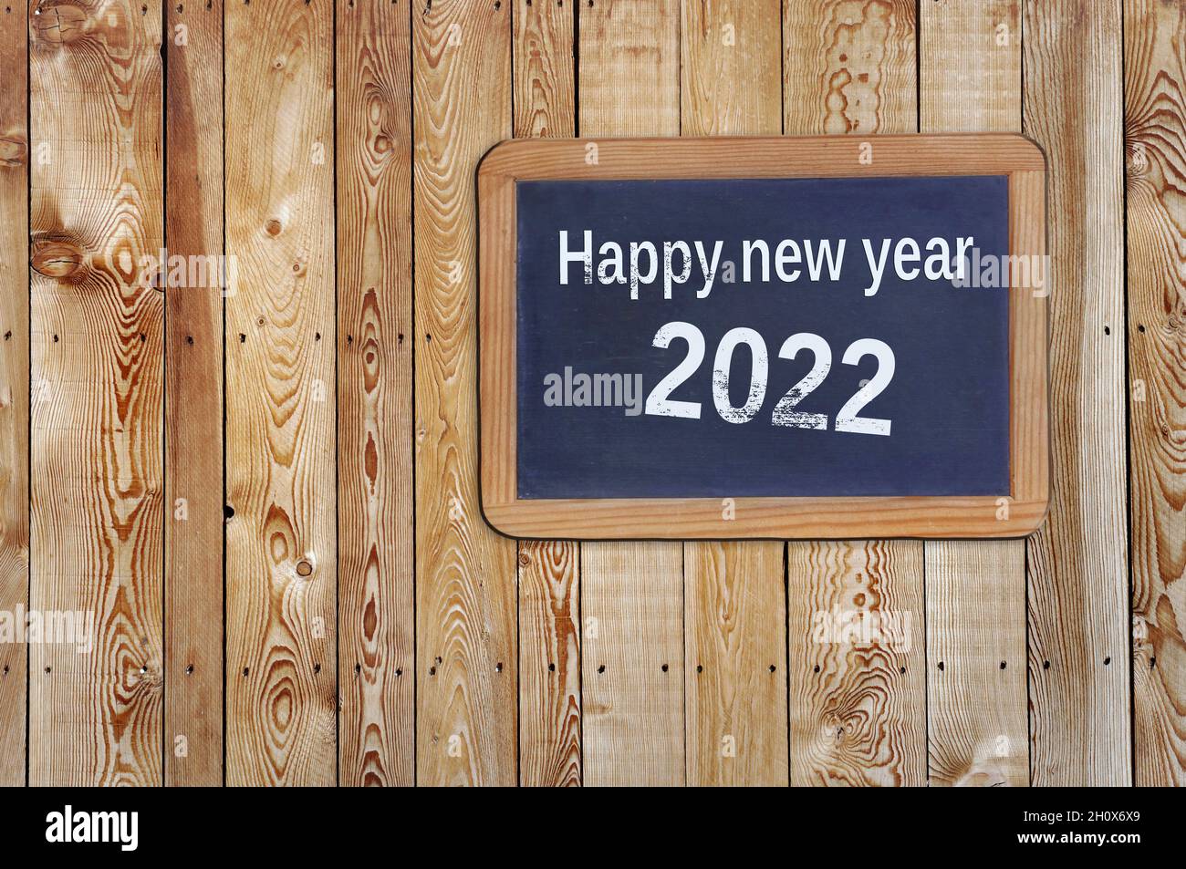 happy new year 2022 written on a slate on rustic plank background Stock ...