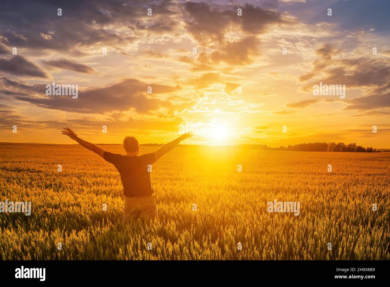 Silhouette of a man raise his hands up to sunset or sunrise on the ...