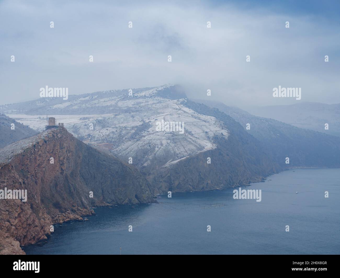 ancient castle ruins on a beautiful rock rise above the sea. winter ...
