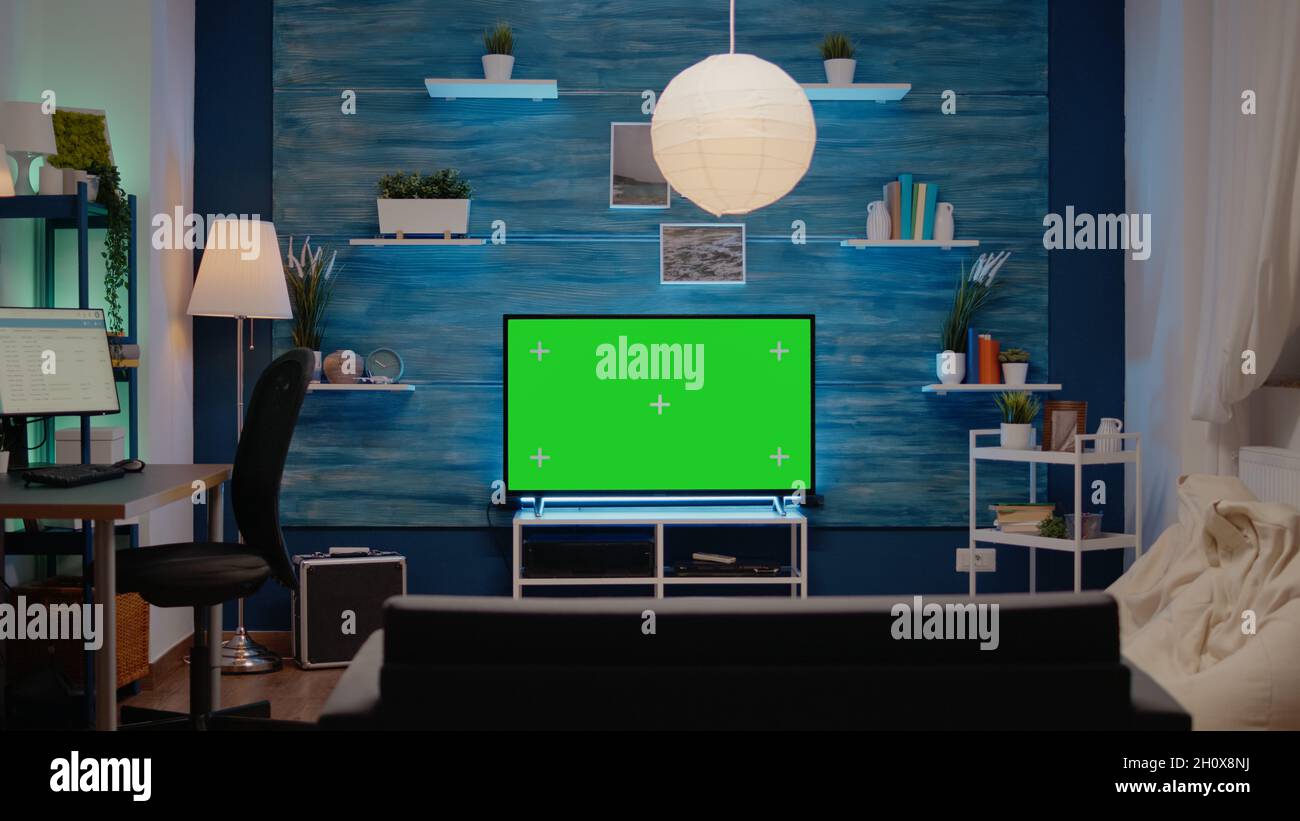 Empty modern room designed with green screen on tv at home. Nobody in ...