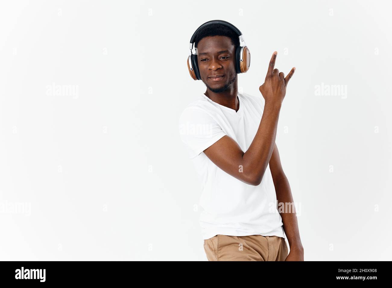 african man wearing headphones music fun technology light background ...